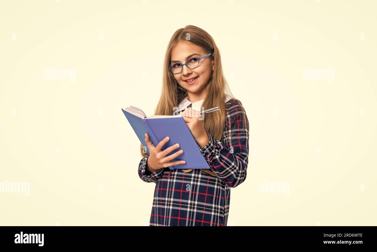 smiling school girl noting notes in studio. school girl noting notes ...
