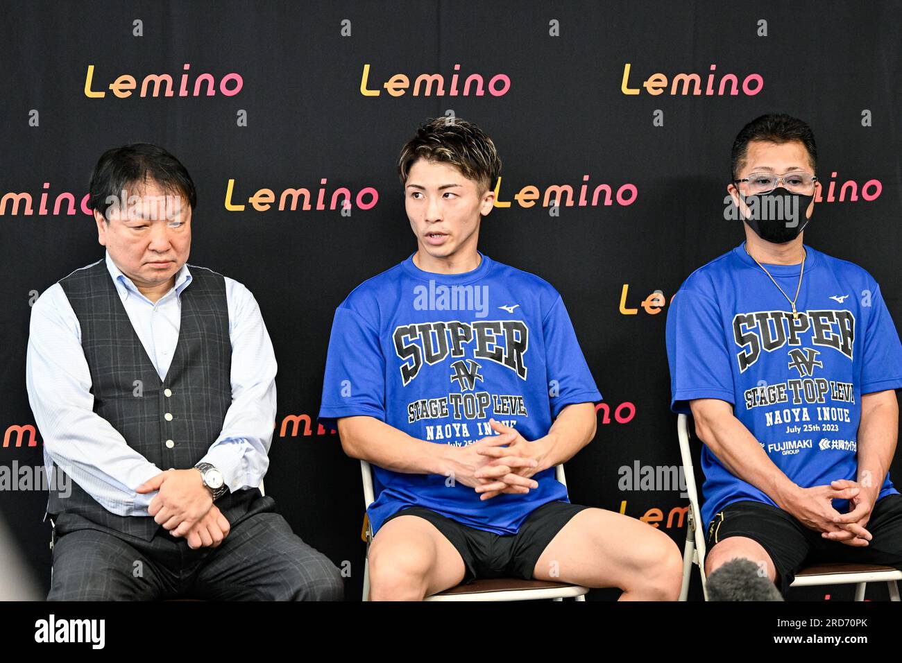 Naoya Inoue of Japan, center, talks to the media with his trainer and ...