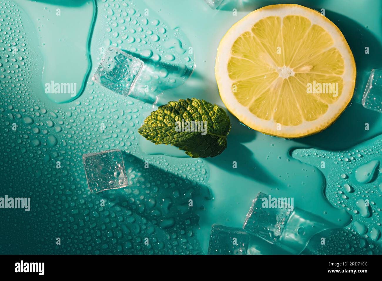 Creative summer composition with lemon slice, mint leaves, can of soda and ice cubes. Top down ...