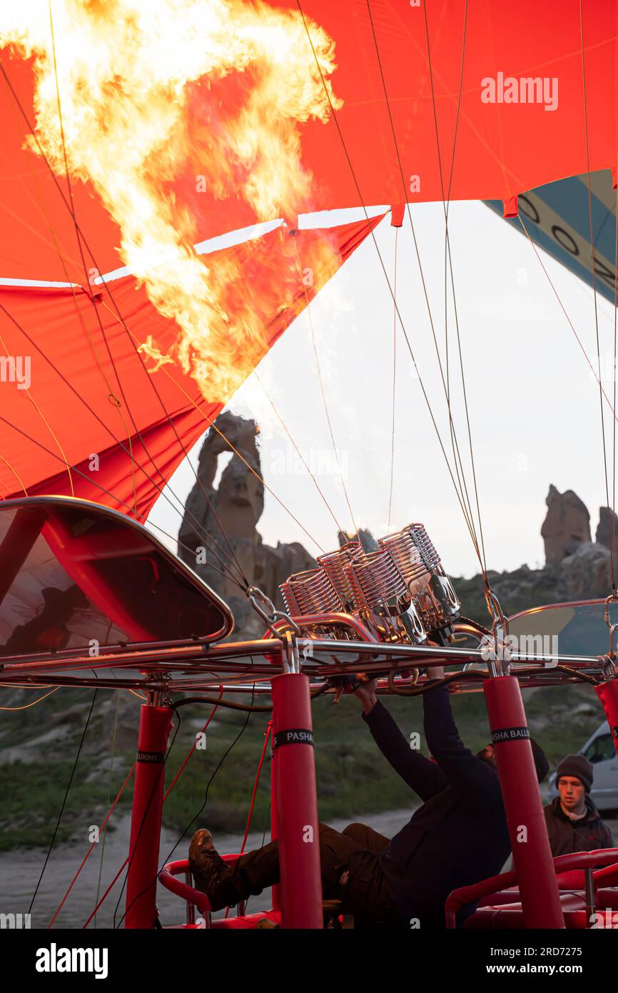 Balloonista firing up air balloon before start. Workers operators ...