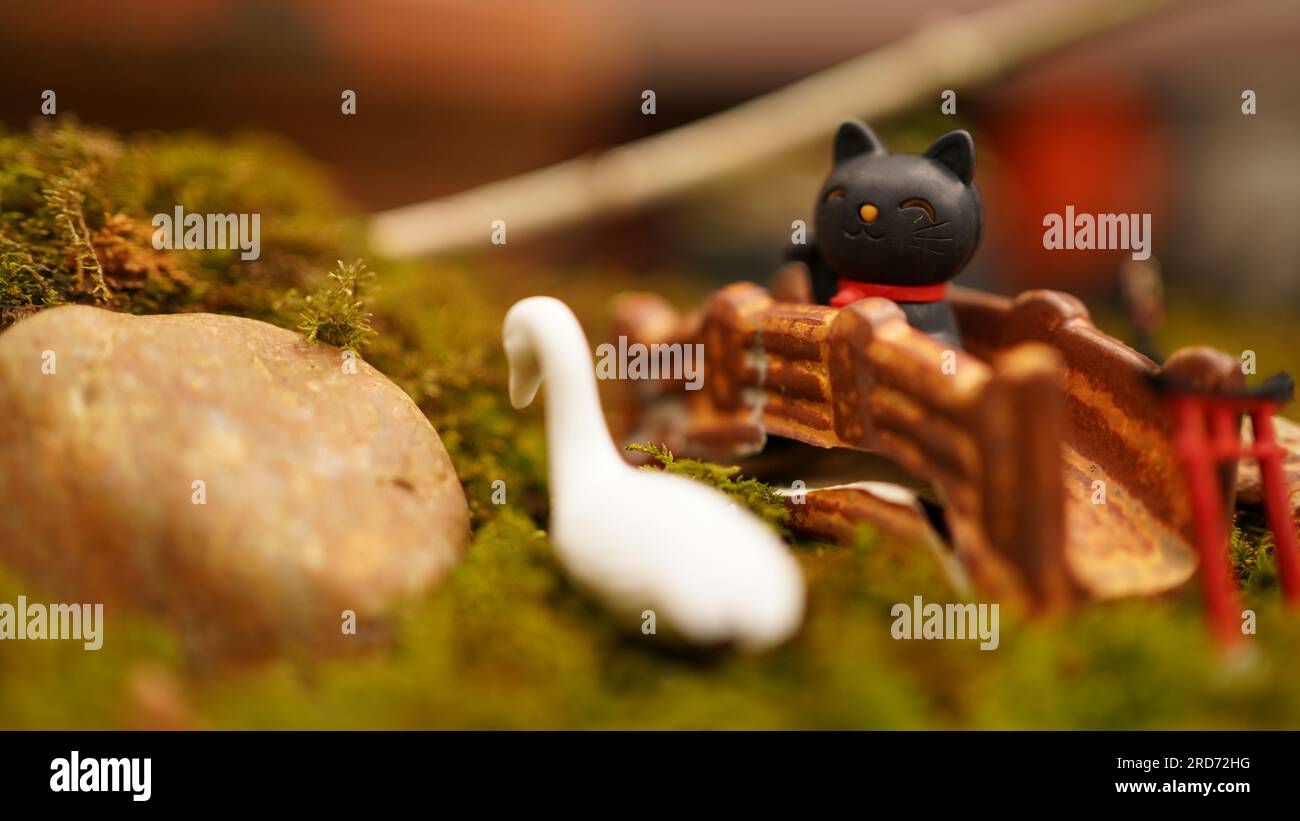 Miniature Cat and Goose on a cute little Landscape with Bridge Stock ...