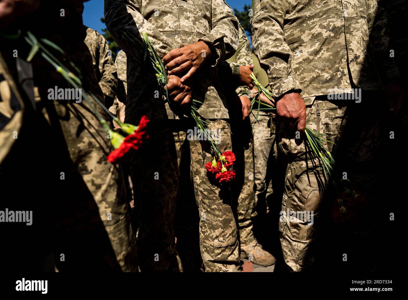 Ukrainian soldiers hold flowers during the farewell ceremony of ...