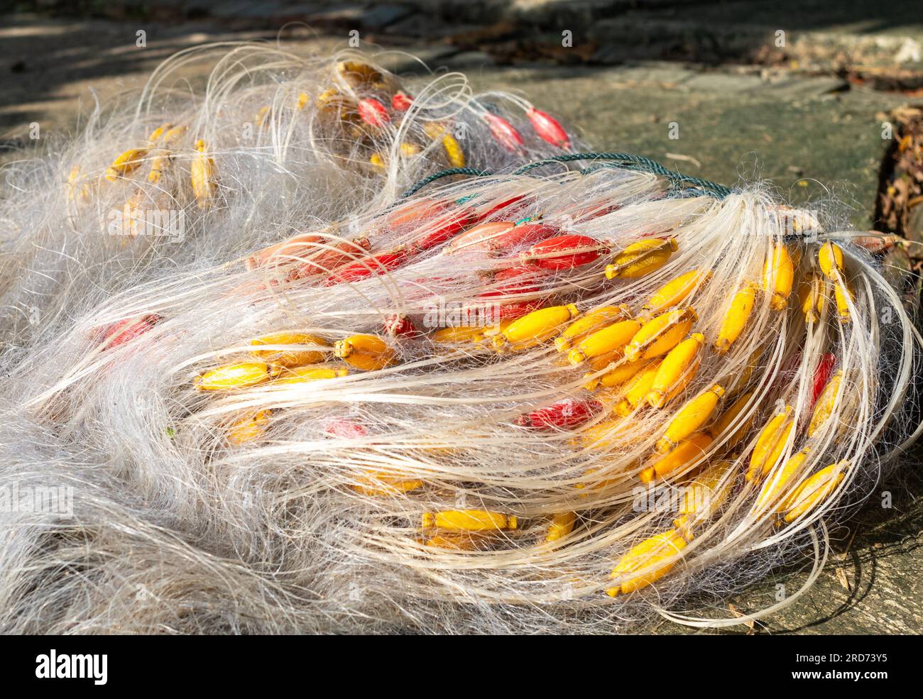 Inshore fishing nets with colourful red and yellow floats laid out in ...