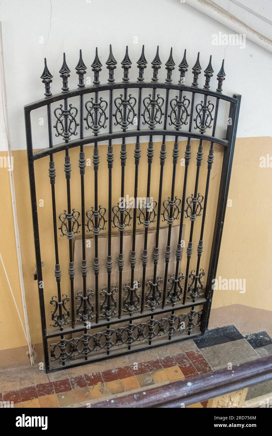 Vintage wrought iron grate in the entrance of an old house. Indoor ...