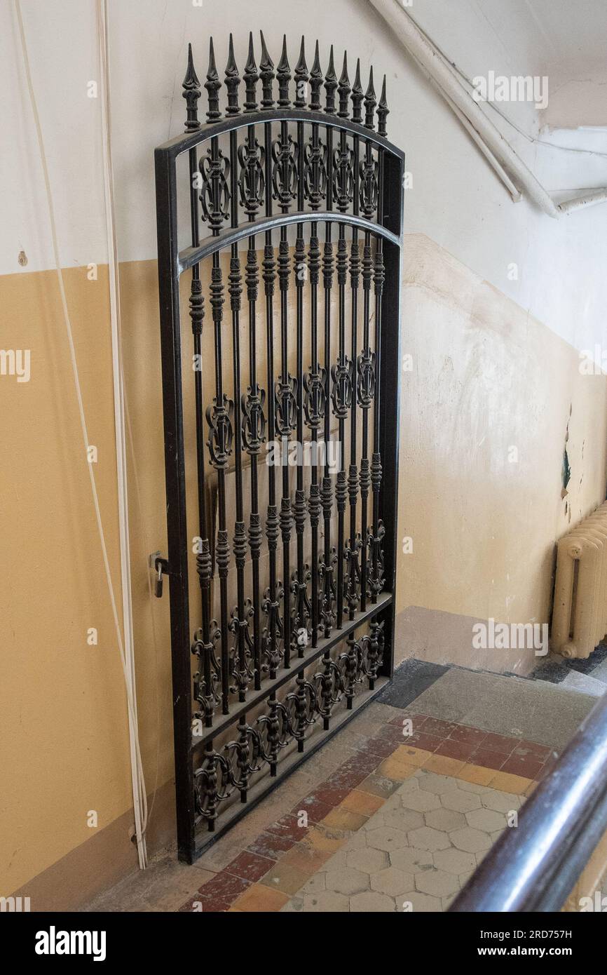 Vintage wrought iron grate in the entrance of an old house. Indoor ...