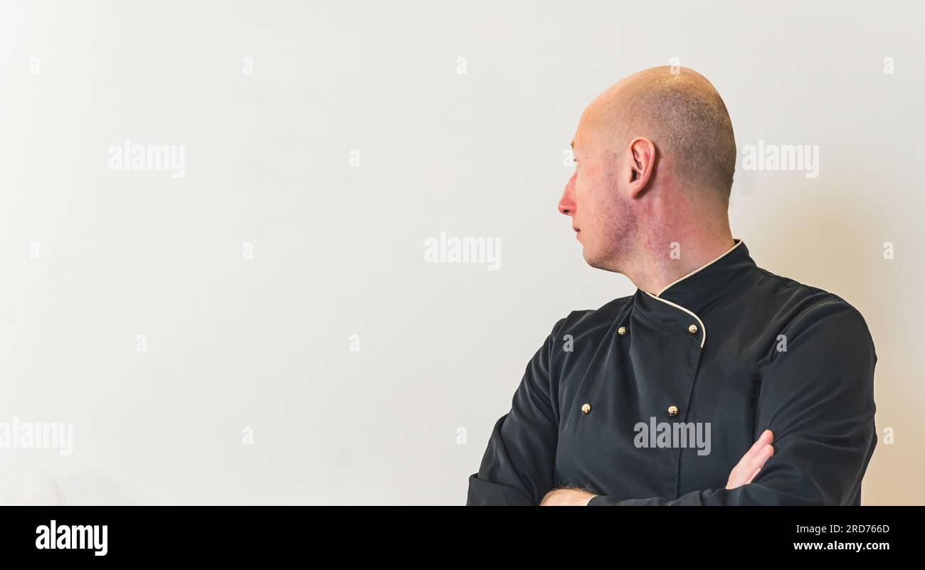 Medium closeup of male chef turning around looking right. Caucasian ...