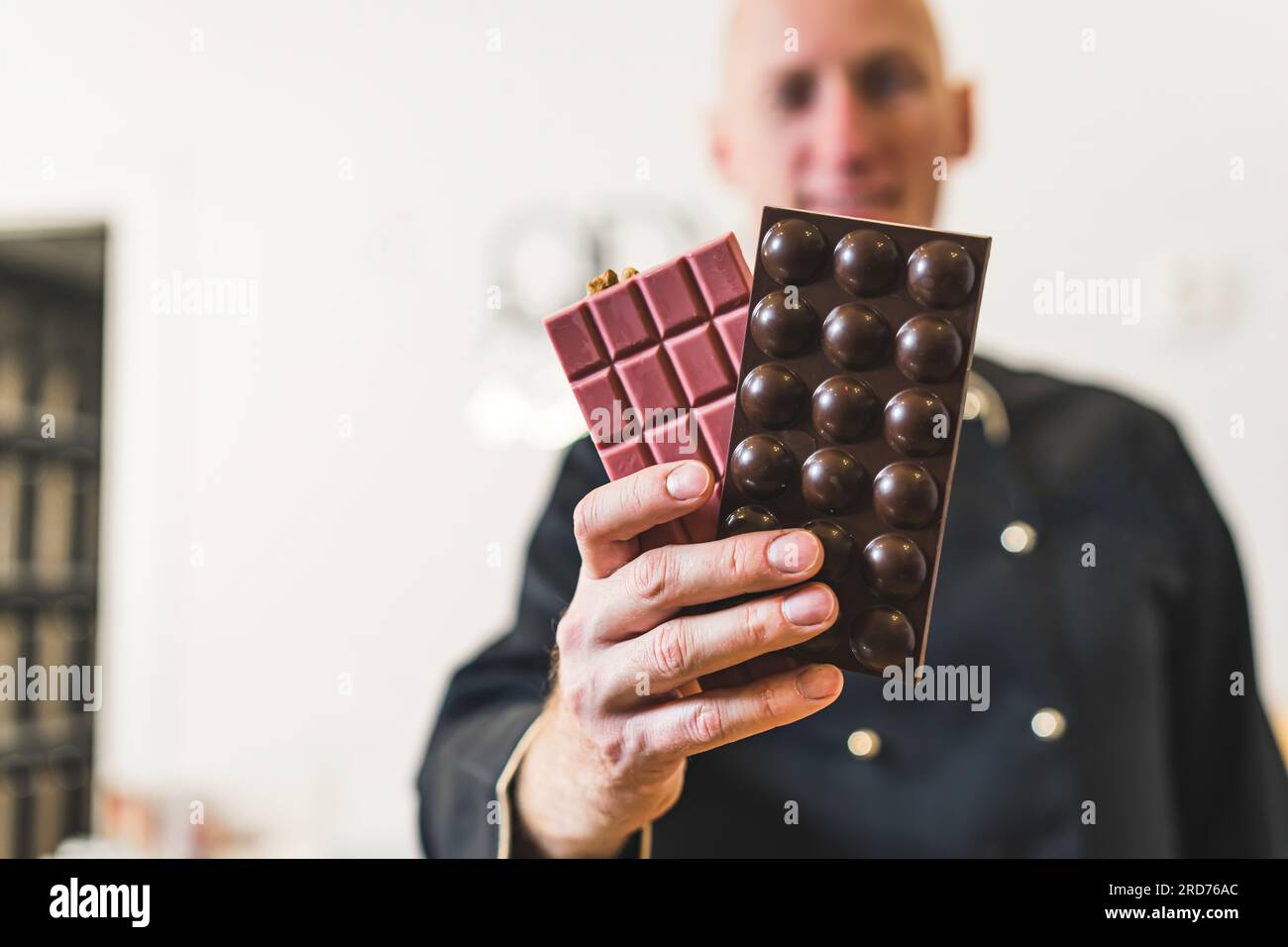 Indoors medium closeup shot of bars of dark chocolate with pieces in ...