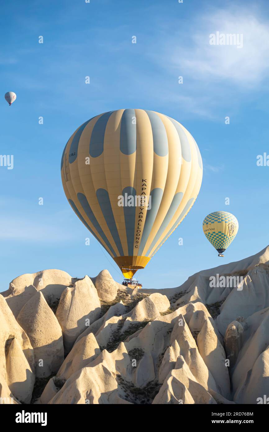 Hot air balloon behind the rocky formation of Rose Valley Cappadocia ...