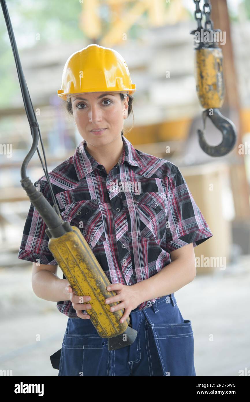 woman controlling hoist with suspended controls Stock Photo - Alamy