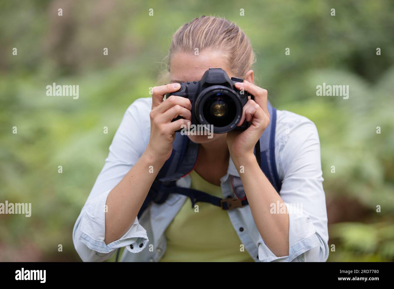 woman in rural setting looking through camera viewfinder Stock Photo ...