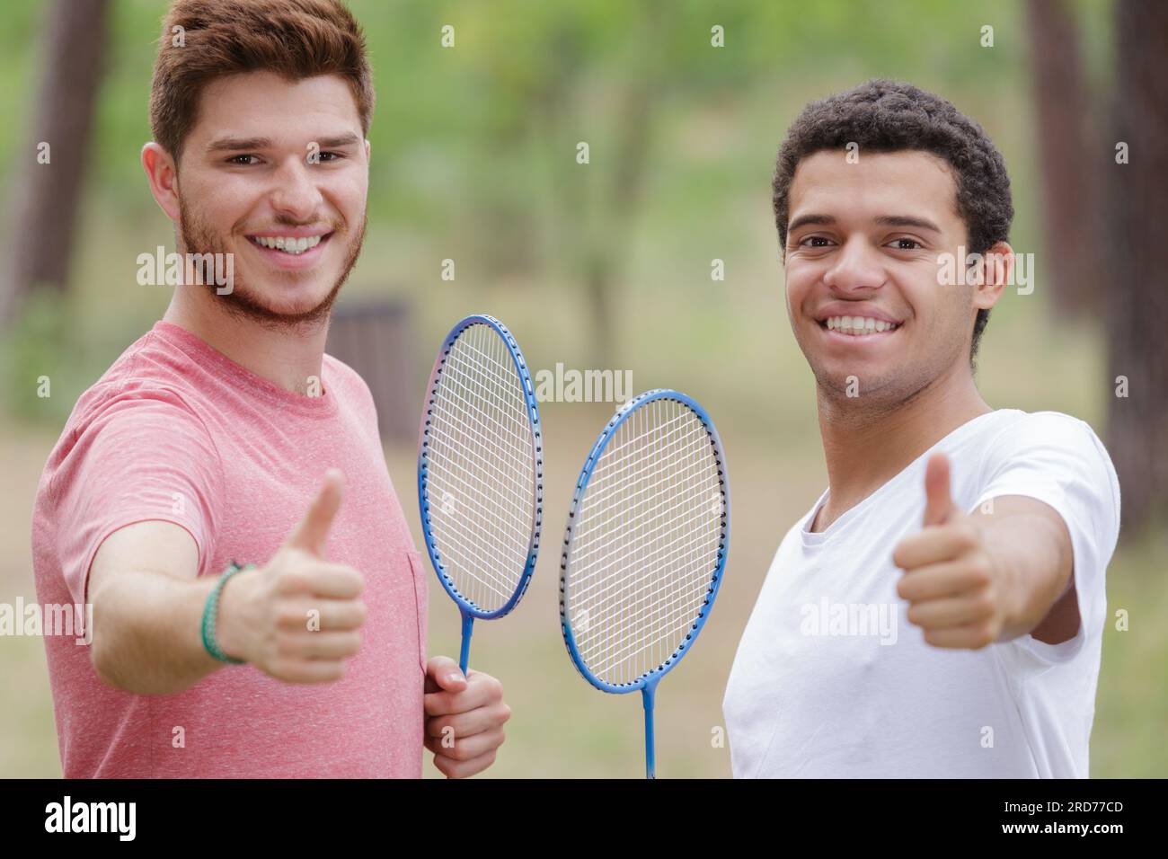 portrait of two male badminton players showing thumbs up Stock Photo ...