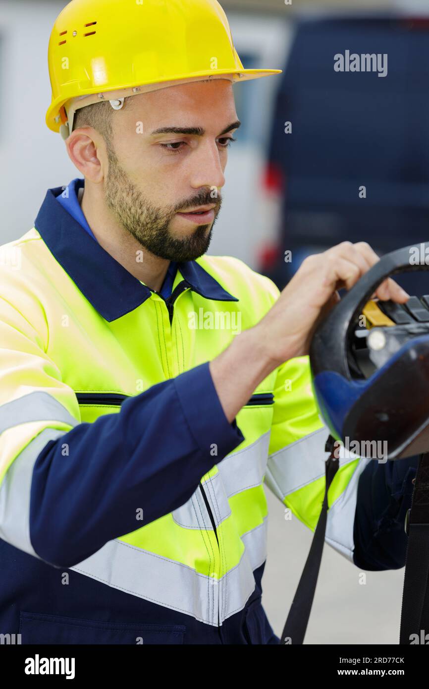 male construction worker operating crane controls Stock Photo - Alamy