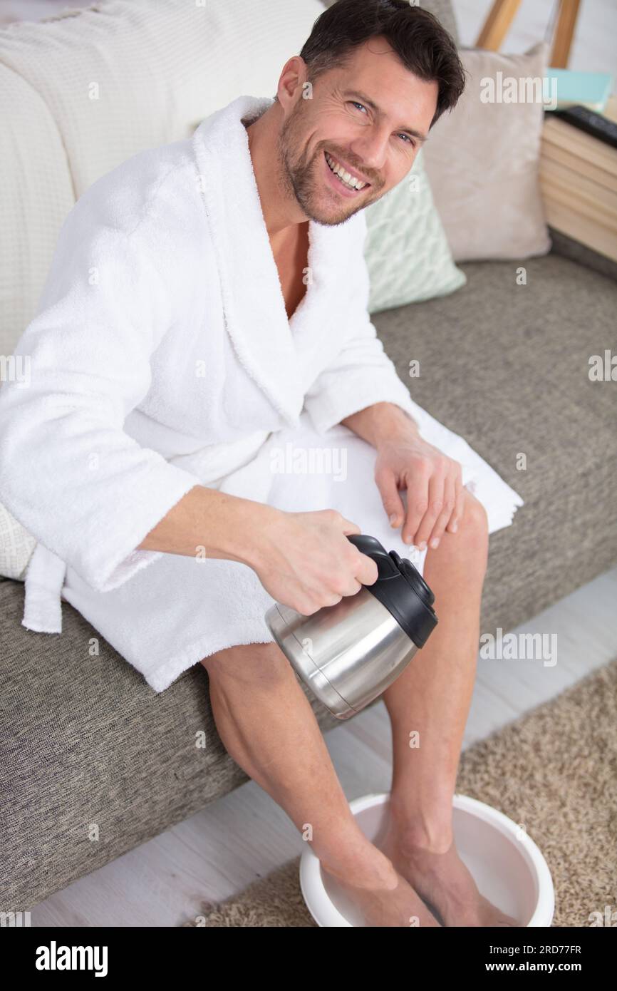 young handsome man having a foot bath Stock Photo - Alamy