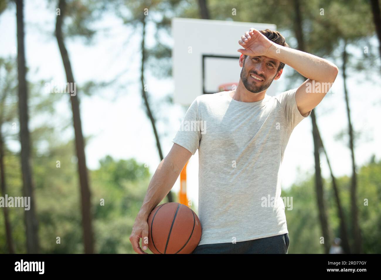 basketball player wipes the sweat from his forehead Stock Photo - Alamy