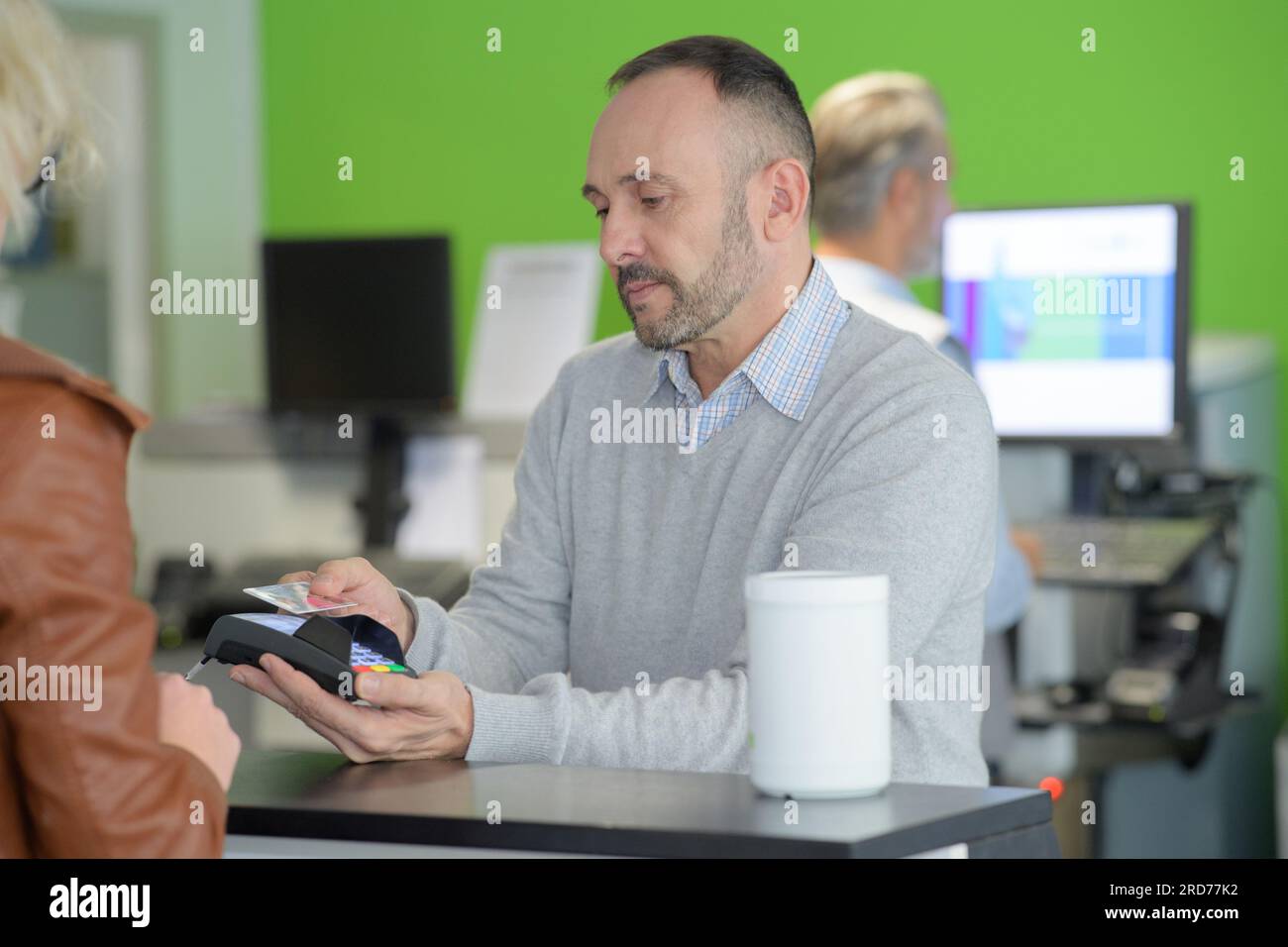 man making transaction at the counter Stock Photo - Alamy