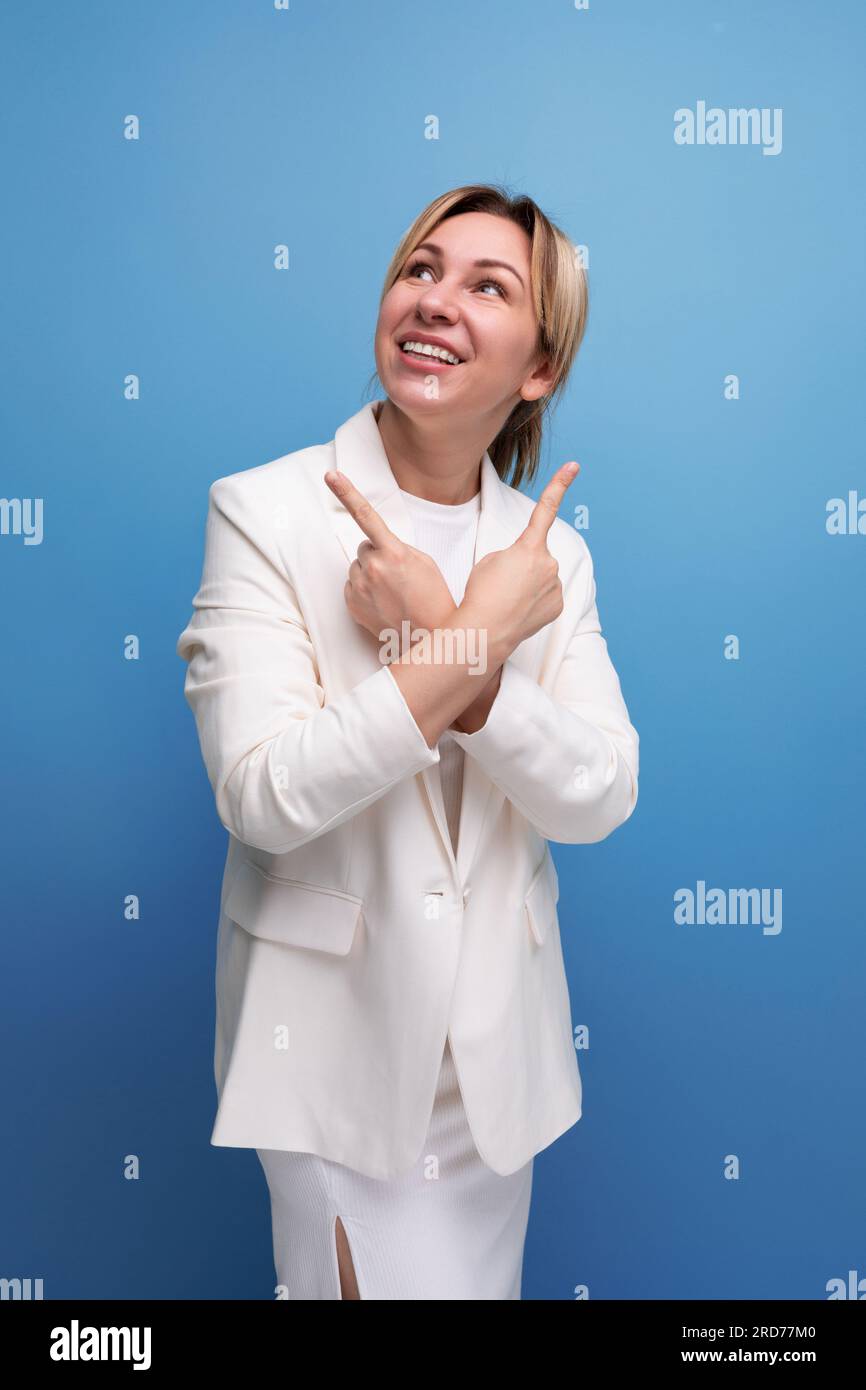 positive slim young caucasian blond lady in white jacket and dress ...