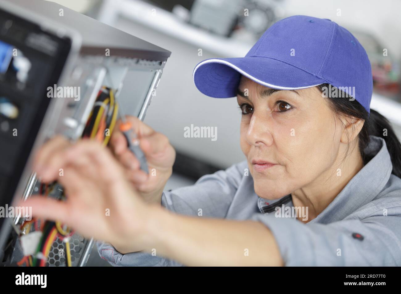 female pc technician soldering a chip from a desktop computer Stock ...