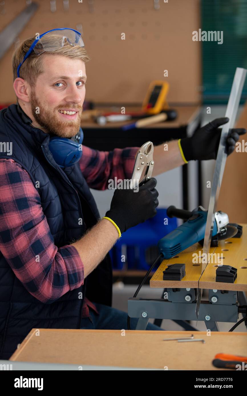 portrait of carpenter posing for the camera in his workshop Stock Photo ...