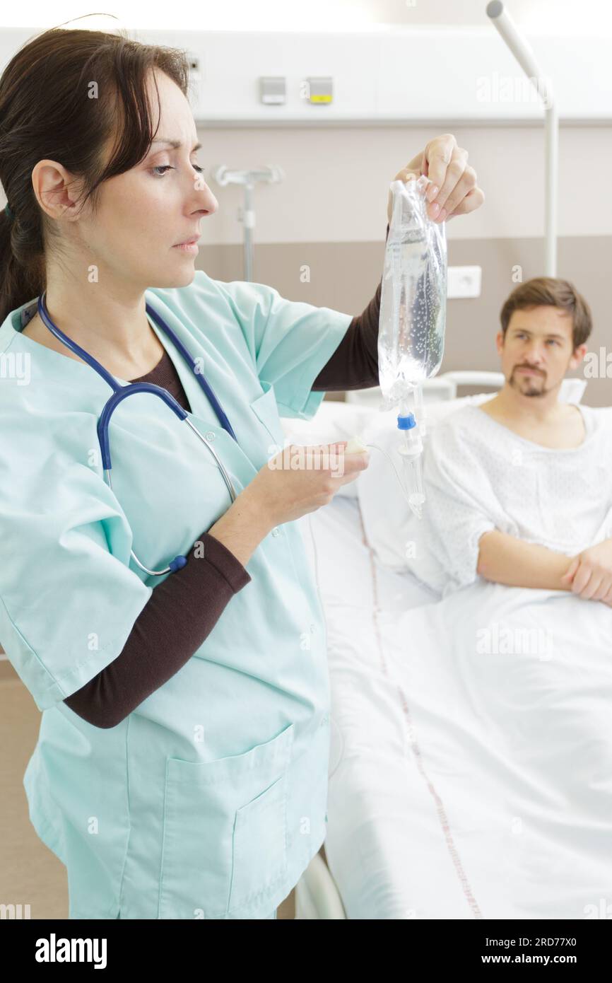nurse checking a vial of medicine Stock Photo - Alamy