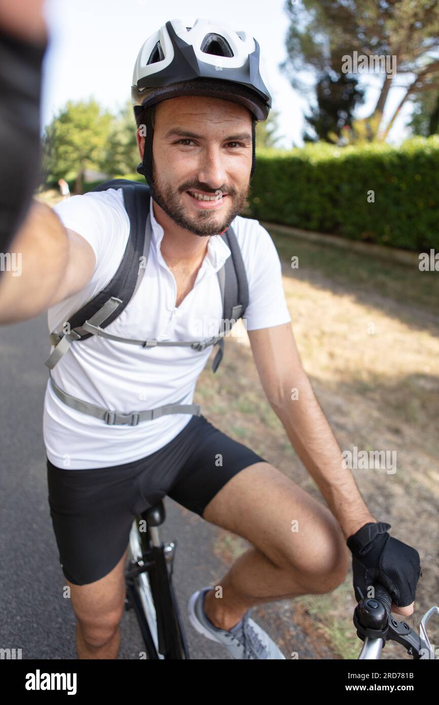 happy smiling cyclist man driving a bike taking selfie photo Stock ...