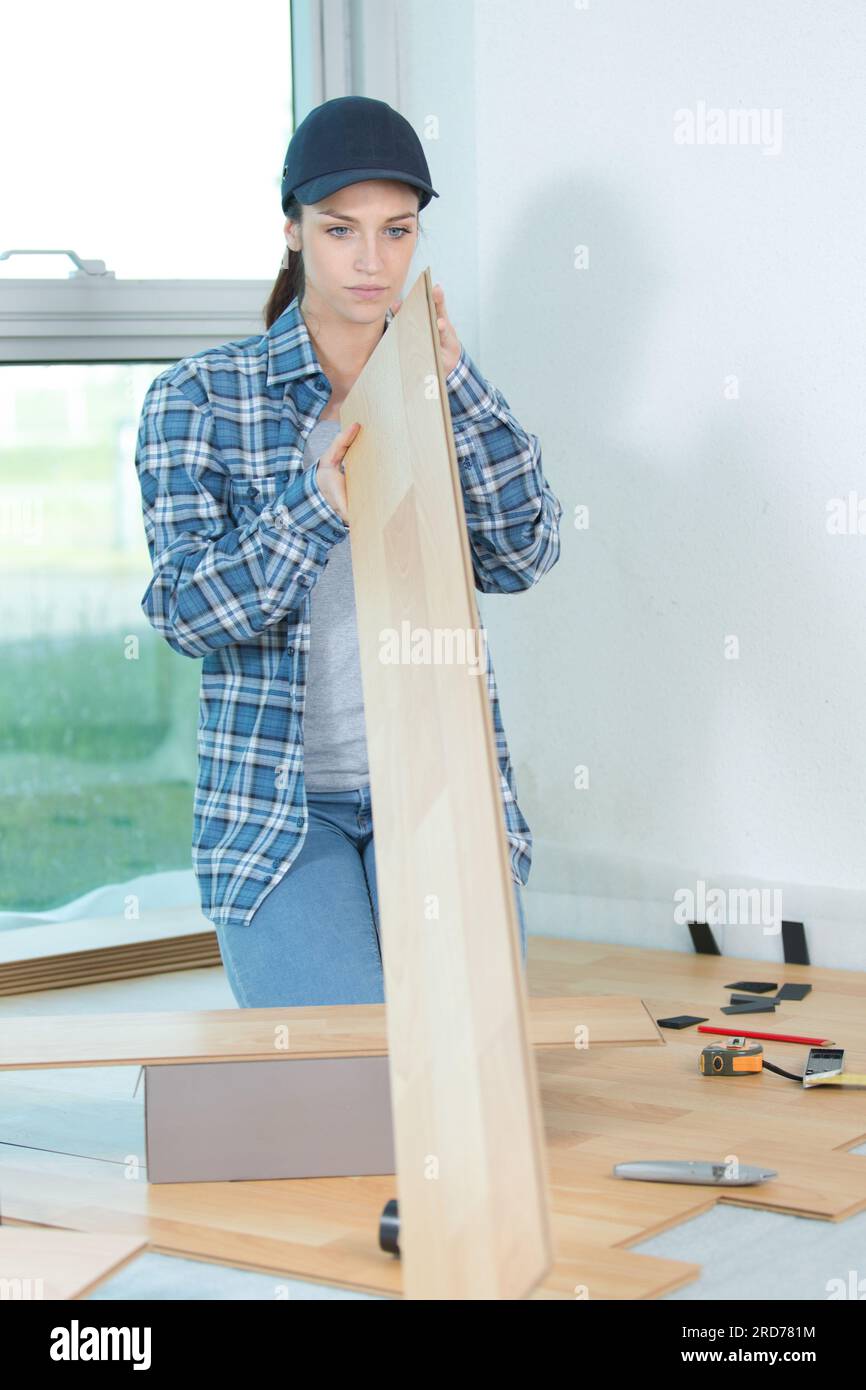 woman checking woodboards for floor Stock Photo - Alamy