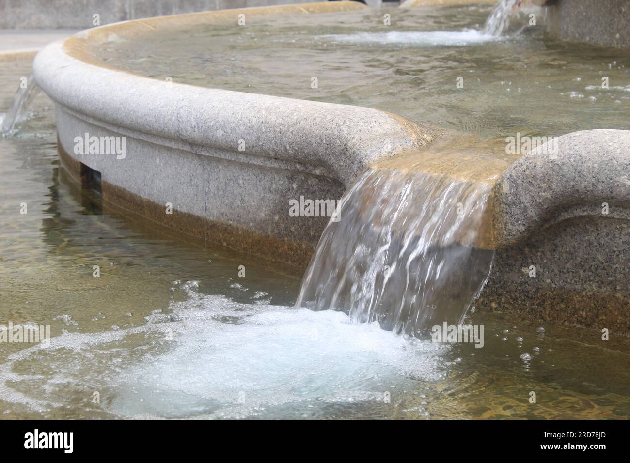 A photo of a mini waterfall splashing in a fountain Stock Photo - Alamy