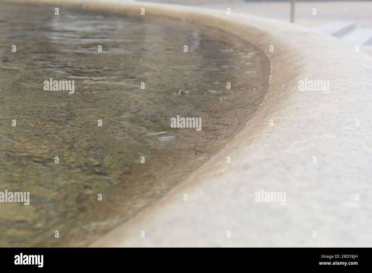 A photo of water on the edge of a fountain Stock Photo - Alamy