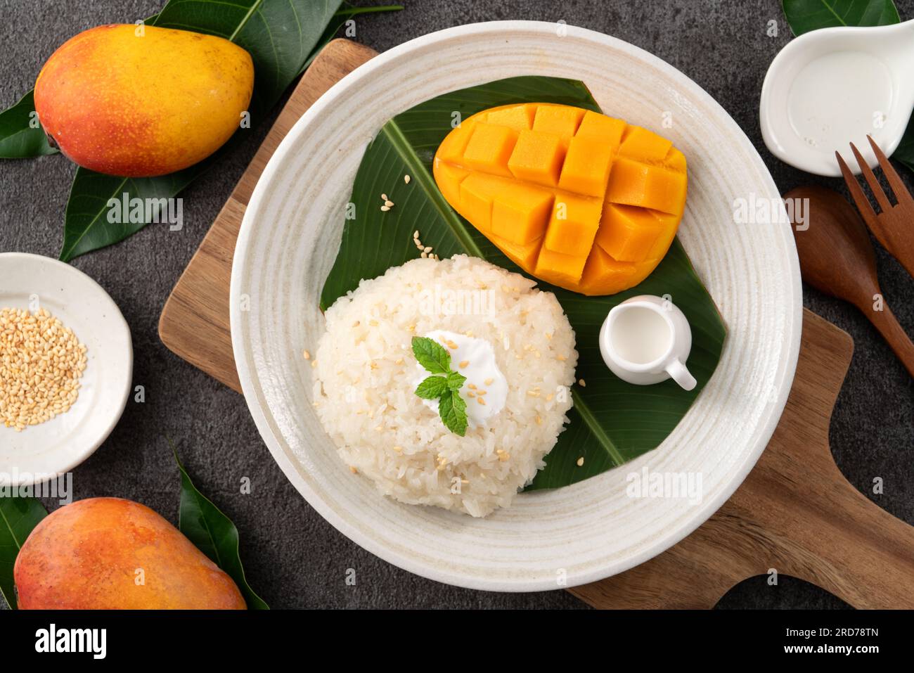 Delicious Thai mango sticky rice with cut fresh mango fruit in a plate ...
