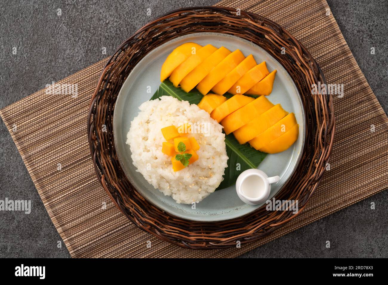 Delicious Thai mango sticky rice with cut fresh mango fruit in a plate ...