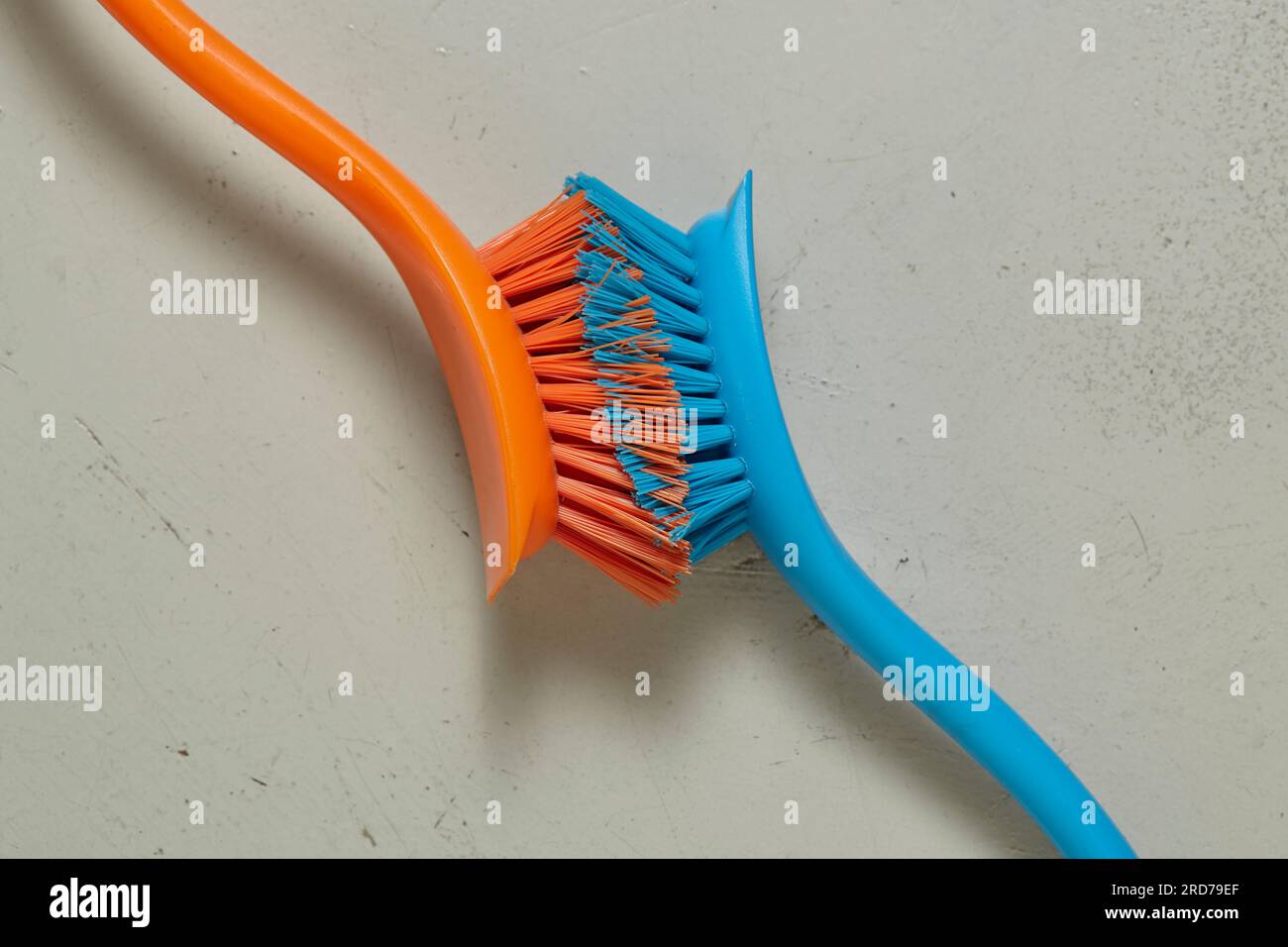Close up of orange and blue brushes with the bristles touching Stock ...