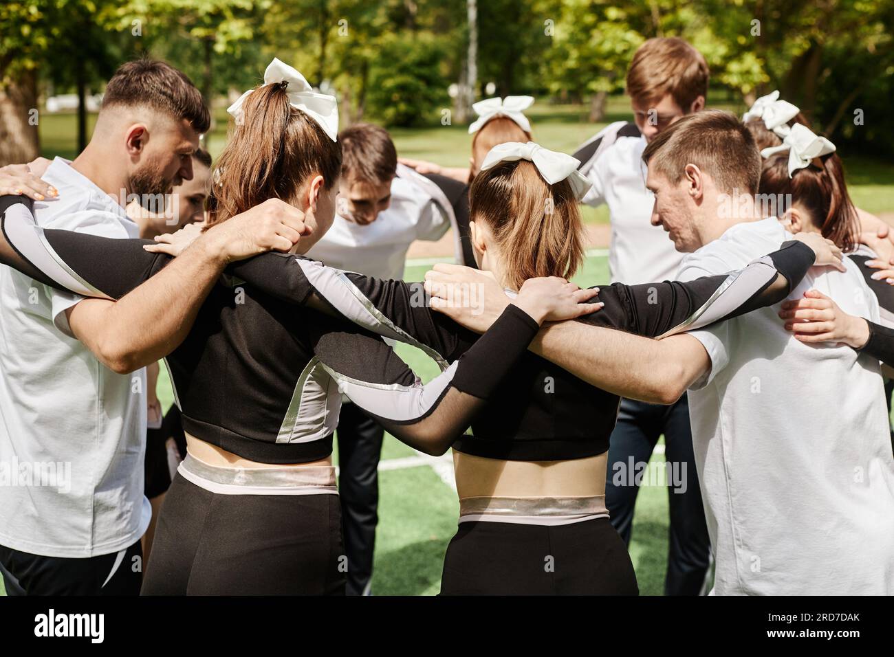 Cheerleader team standing in circle and saying the words of support to ...