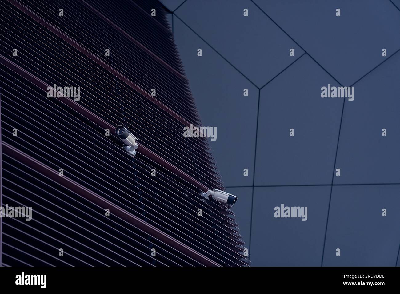 Security cameras are installed on the mirrored dark building. To check ...