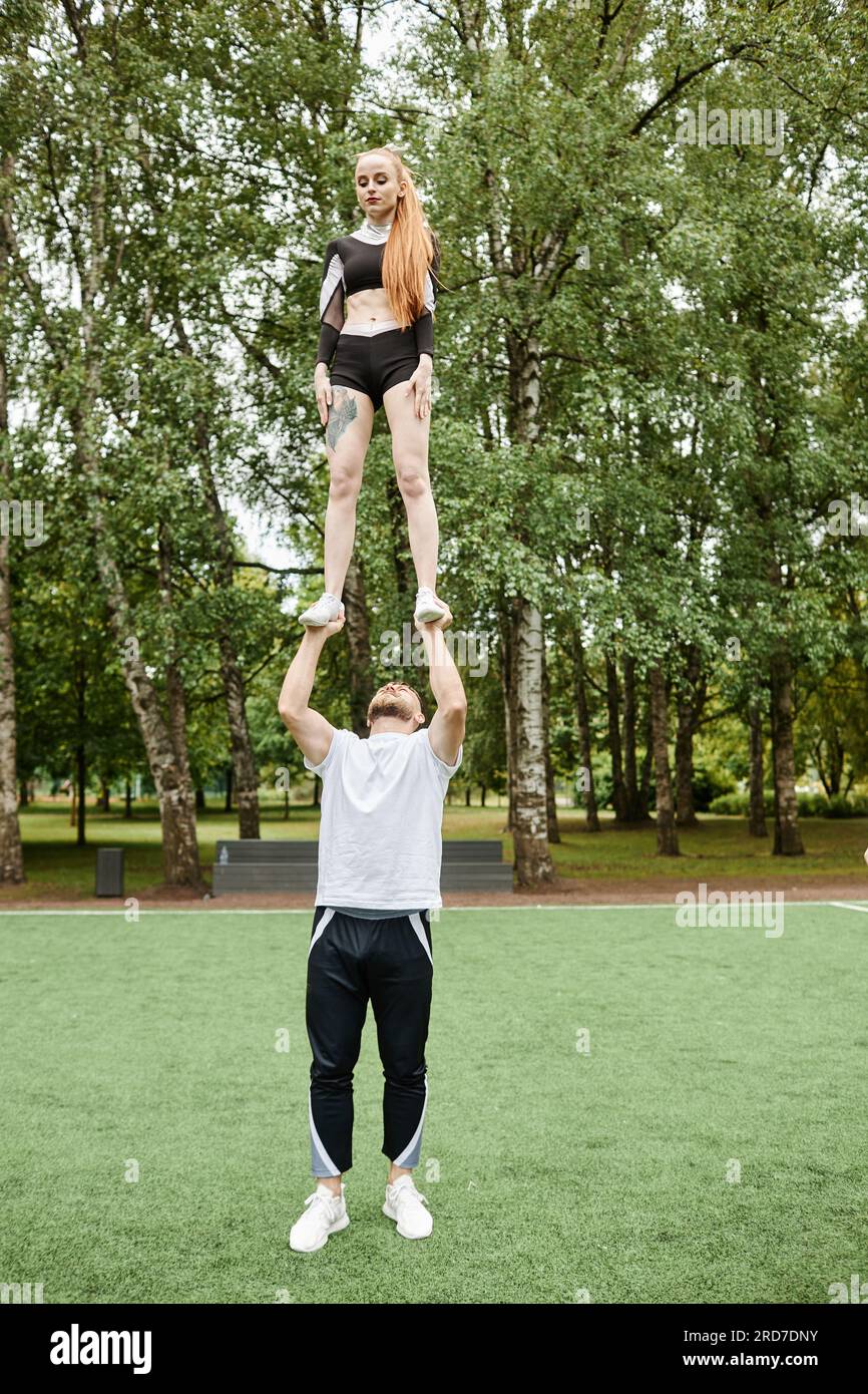 Vertical image of young girl from cheerleading team doing trick ...