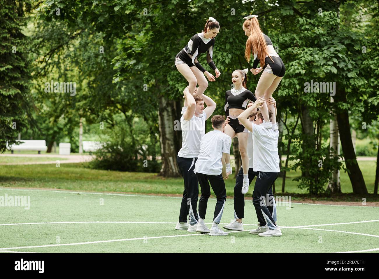 Cheerleading team doing tricks at performance outdoors Stock Photo - Alamy