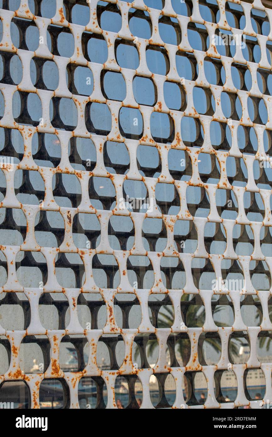 metal security grill or shutter covering a shop window to protect ...