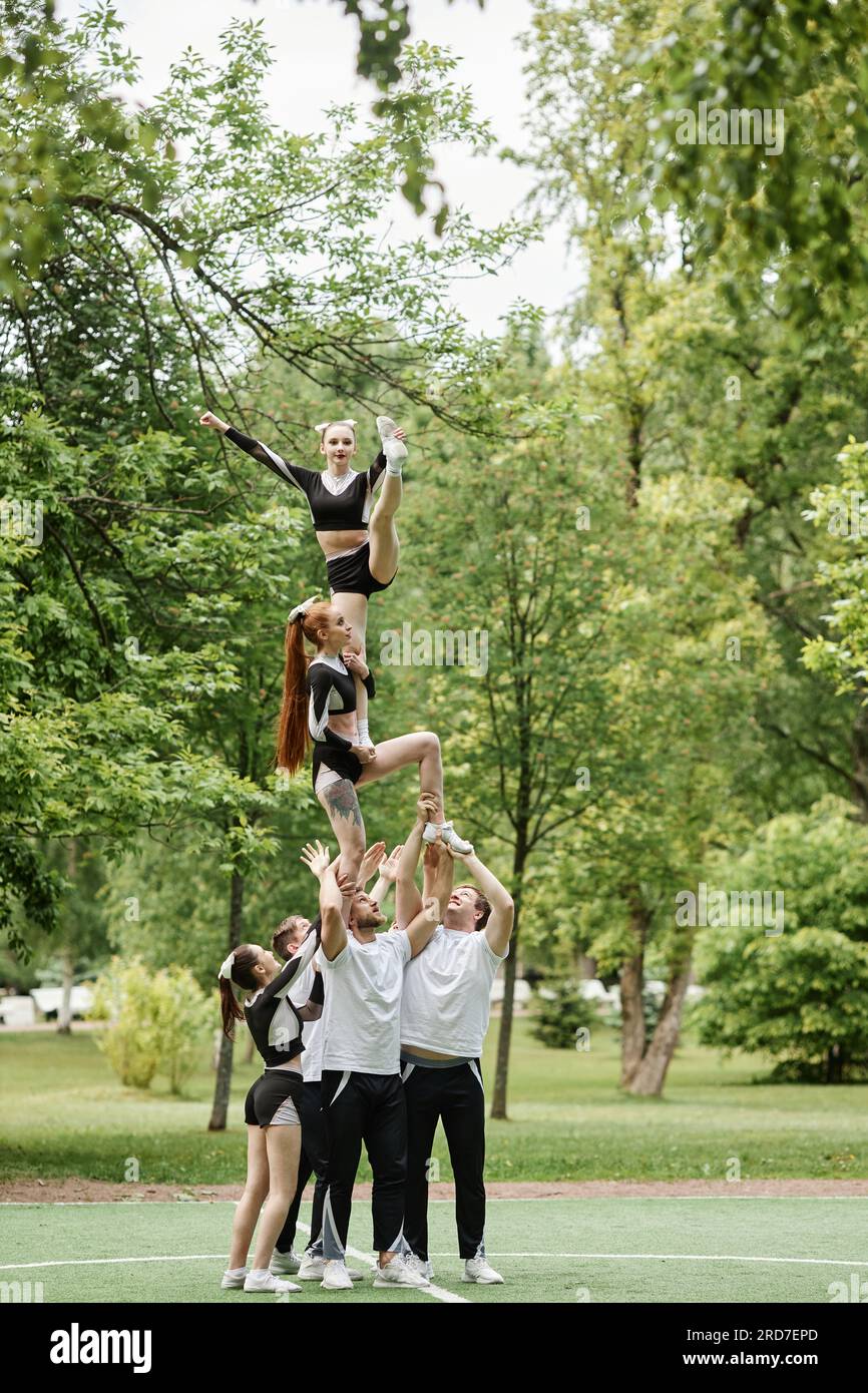 Vertical image of cheerleader team performing at competition outside ...