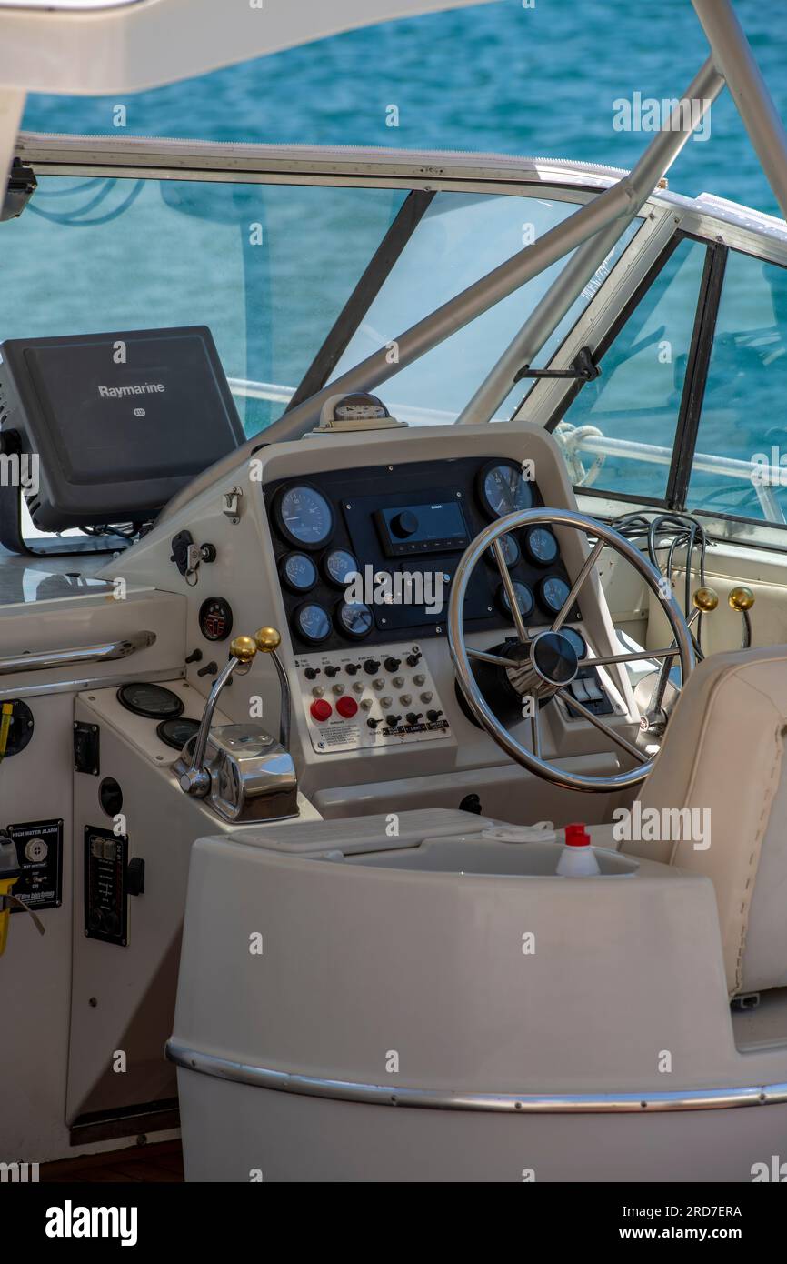 controls and steering wheel on a modern powerboat or motorboat, seat ...