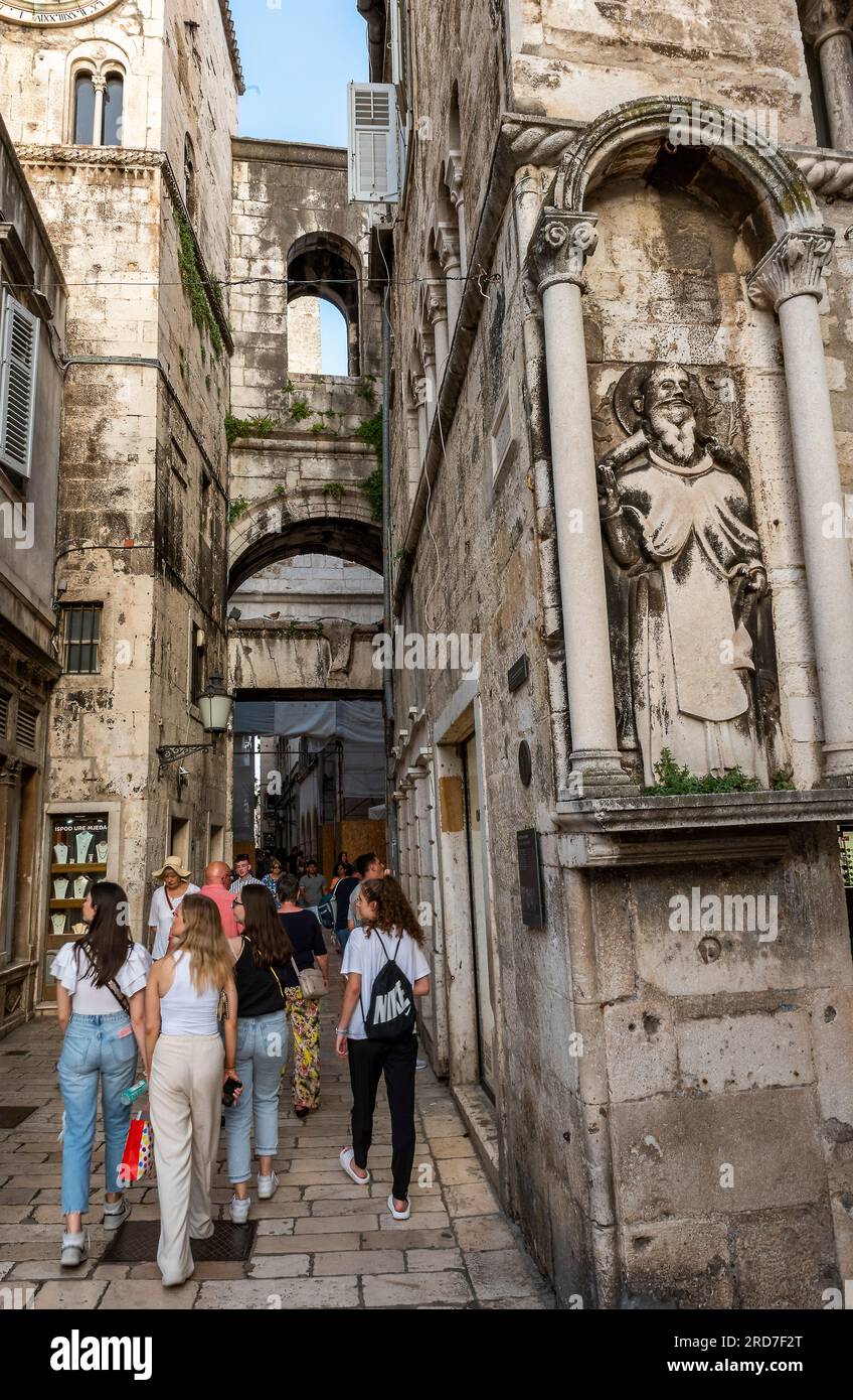 tourists walking past the statue of saint antony on ciprianis palace in ...