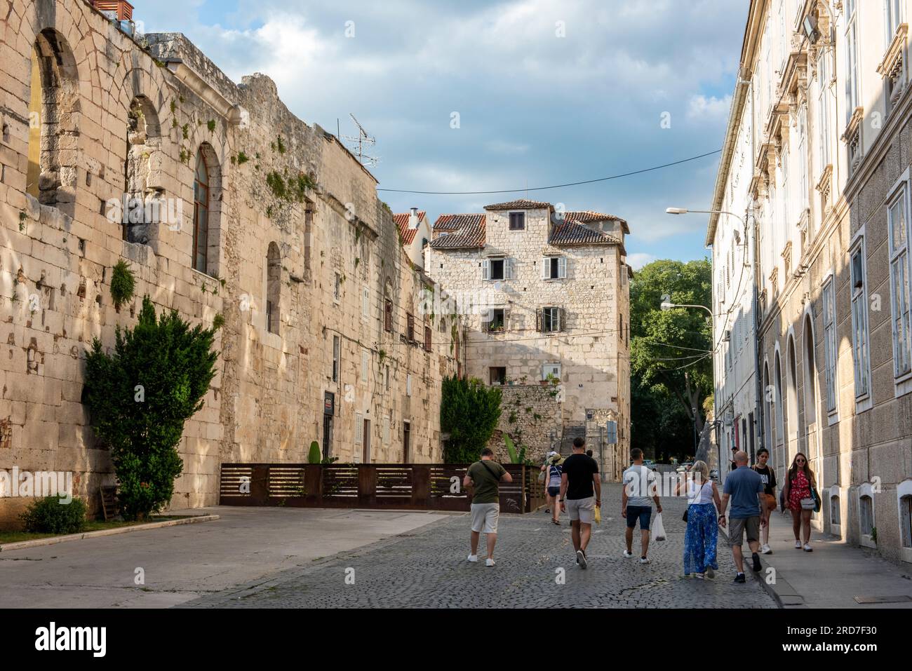 tourists walking along a steet in the old town area of grad split in ...