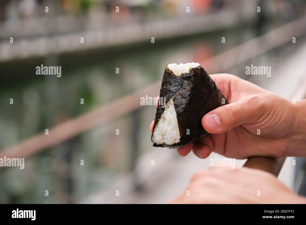 Tourist eating onigiri street hi-res stock photography and images - Alamy