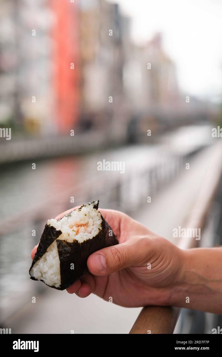 Tourist eating onigiri street hi-res stock photography and images - Alamy