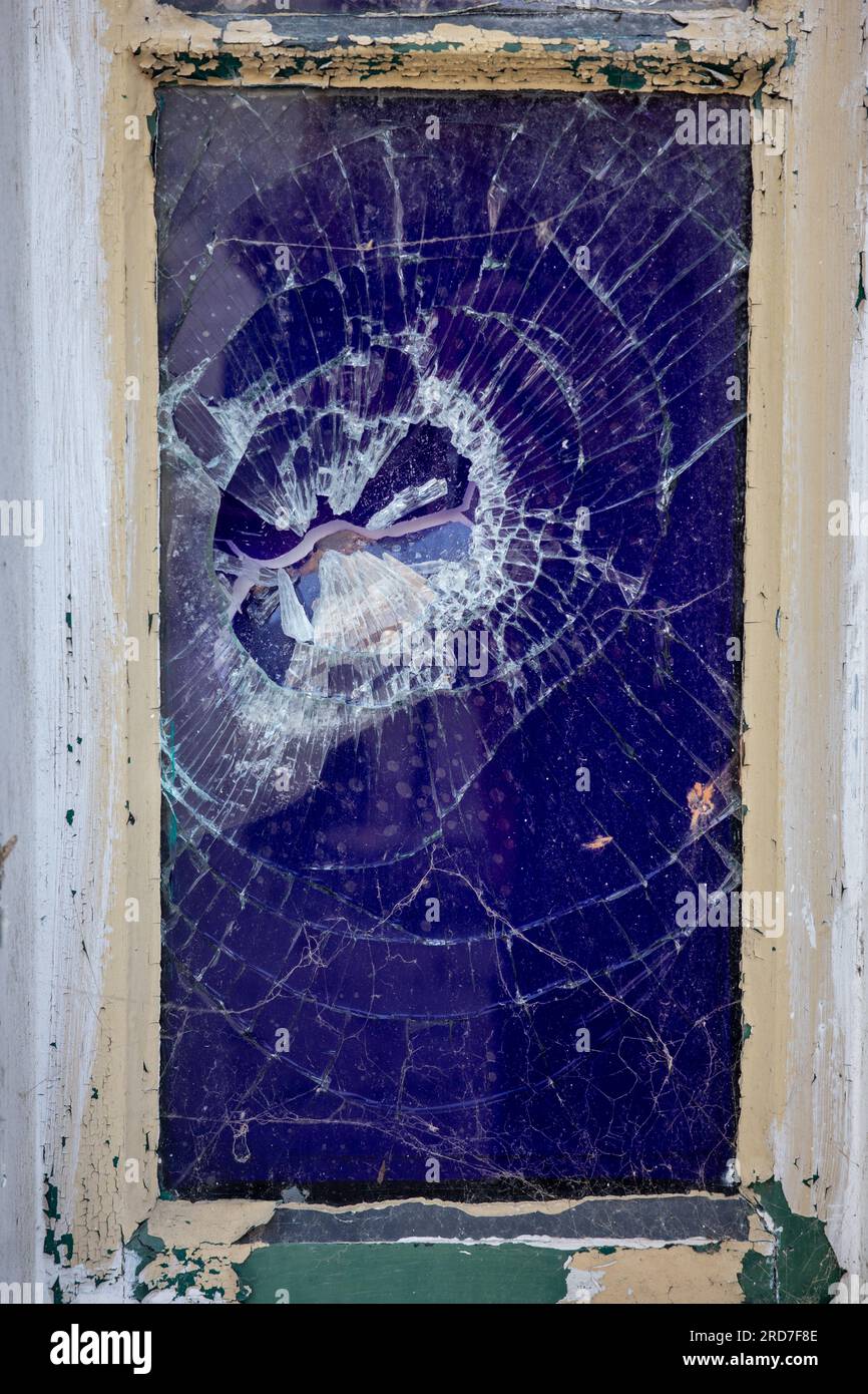 Broken blue glass window Stock Photo - Alamy