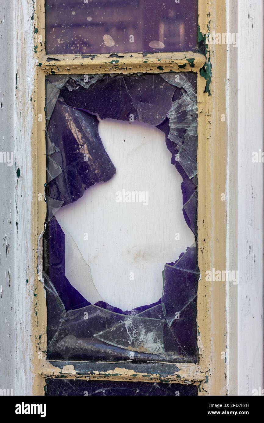 Broken blue glass window Stock Photo - Alamy