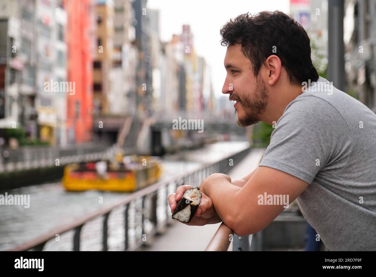 Tourist eating onigiri at street Stock Photo - Alamy