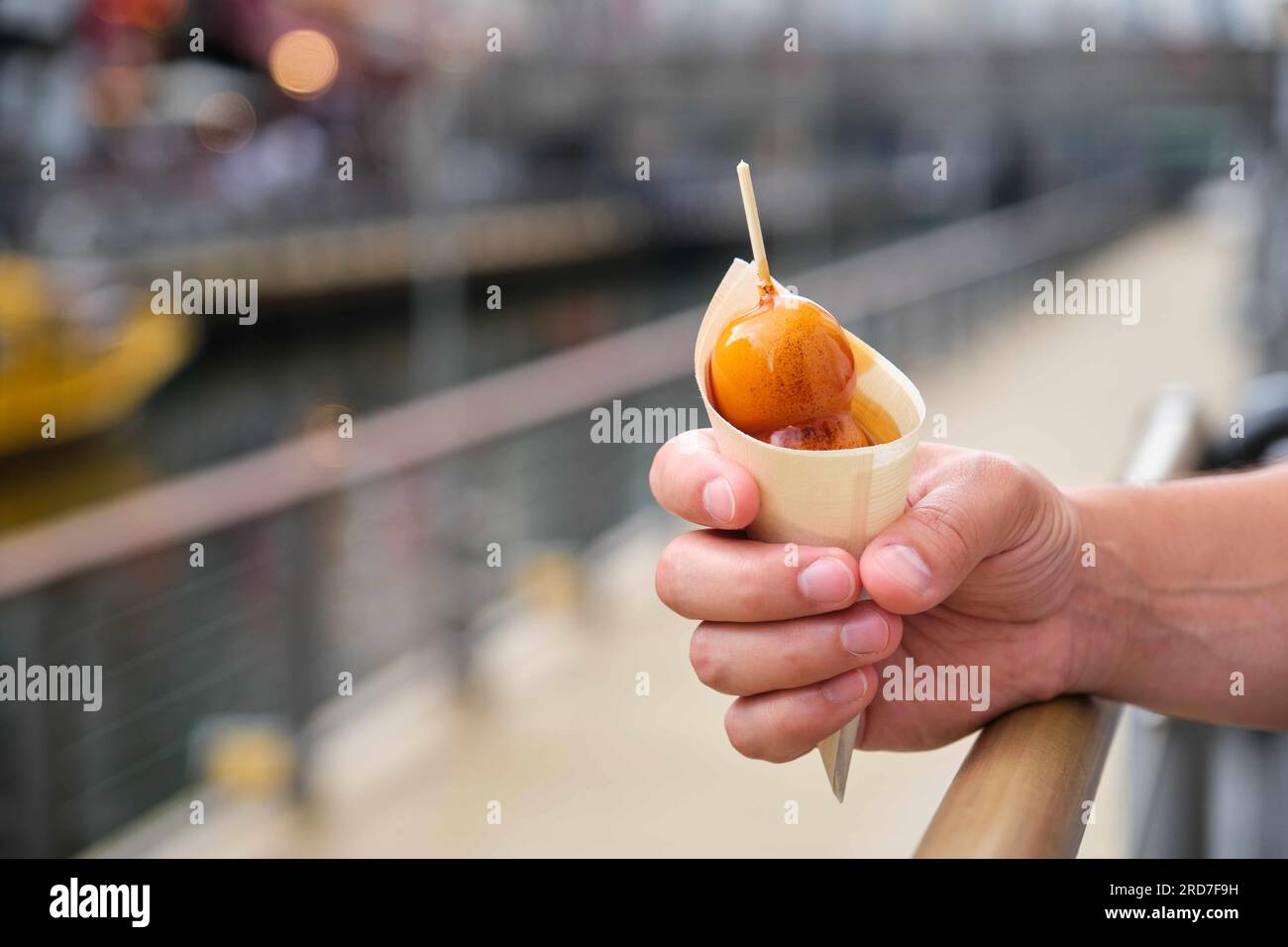 Unrecognizable person eating mitarashi dango at street Stock Photo - Alamy