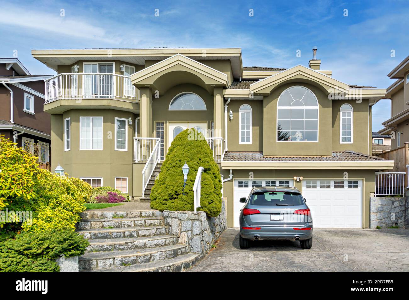 Luxury residential house with a car parked in front on cloudy day Stock ...