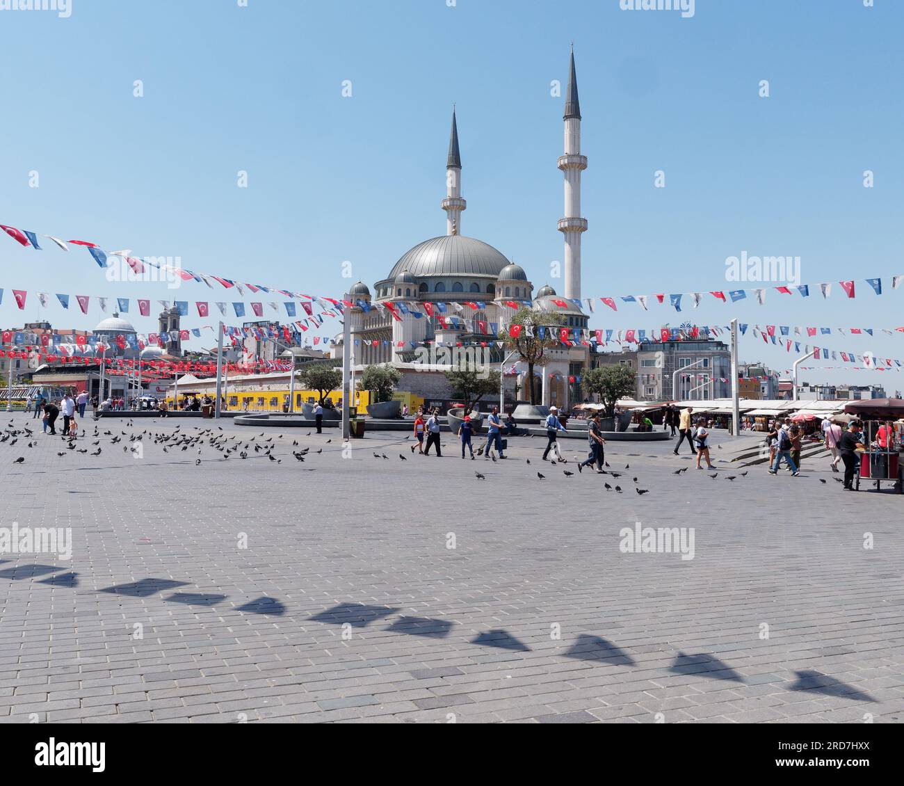 Taksim Square criss crossed by bunting and Taksim Mosque on a summers ...