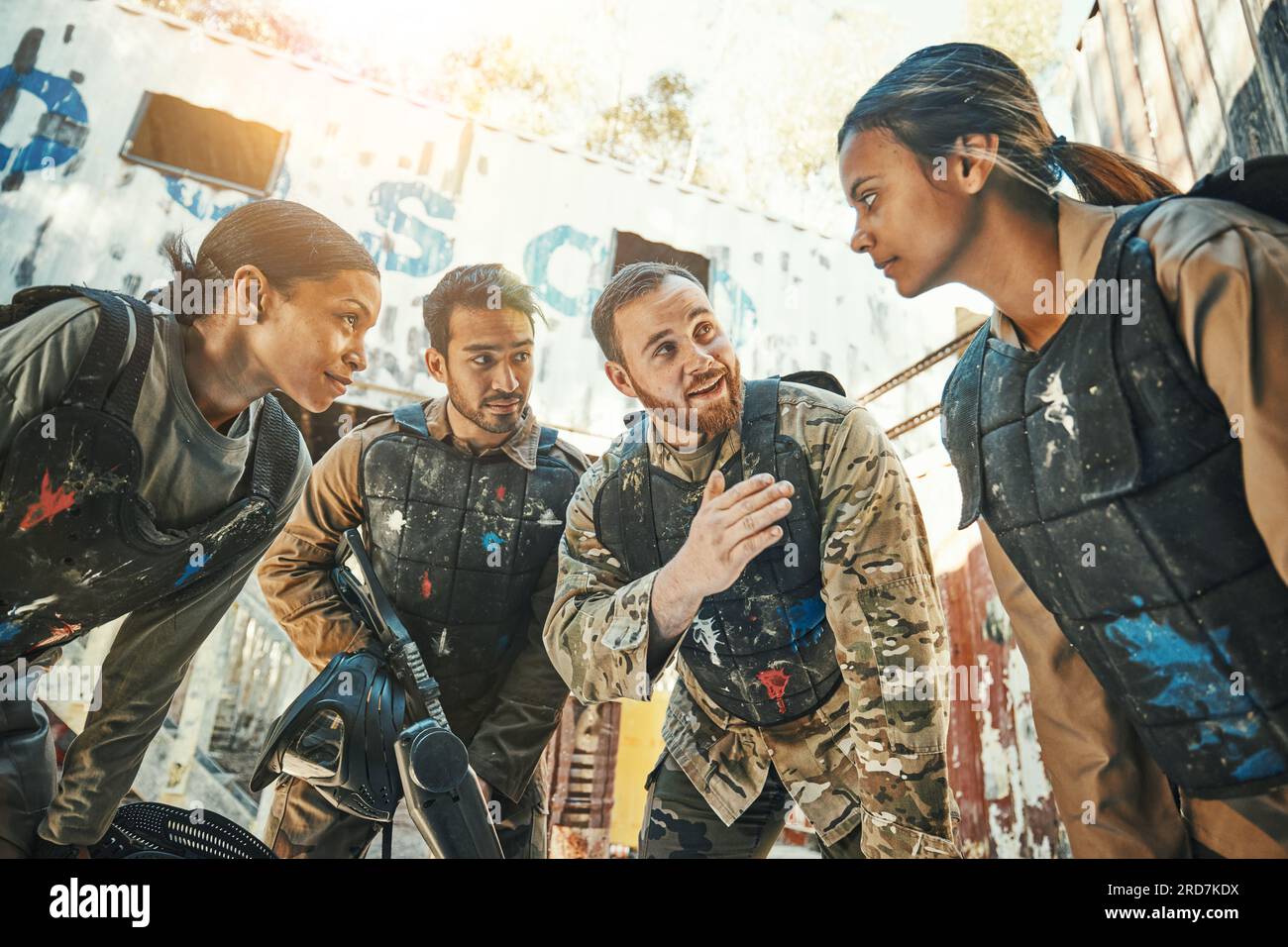 Paintball game, group strategy and team discussion, conversation or ...