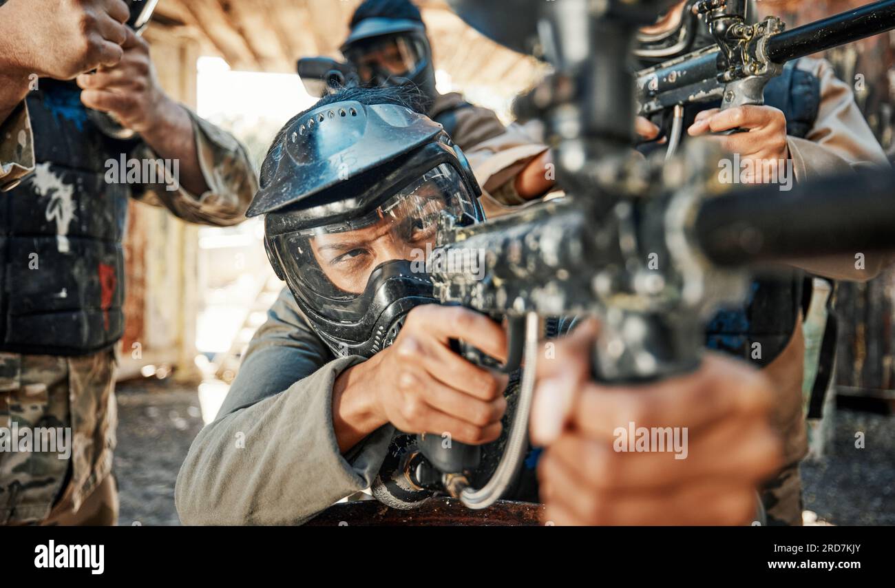 Paintball game, gun and man aim, shooting focus and target soldier ...