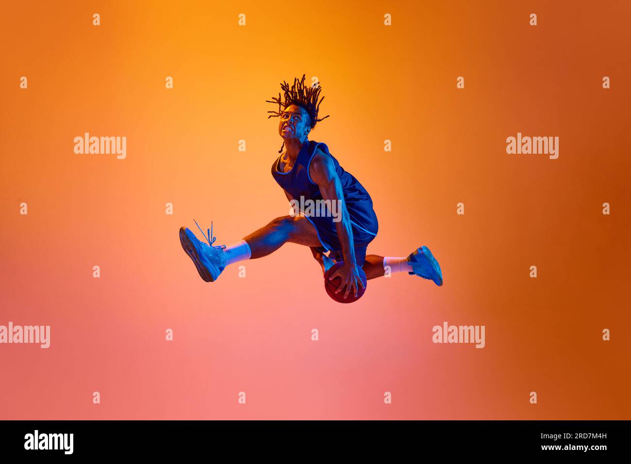 Slam dunk position. Athletic young man, basketball player in motion ...